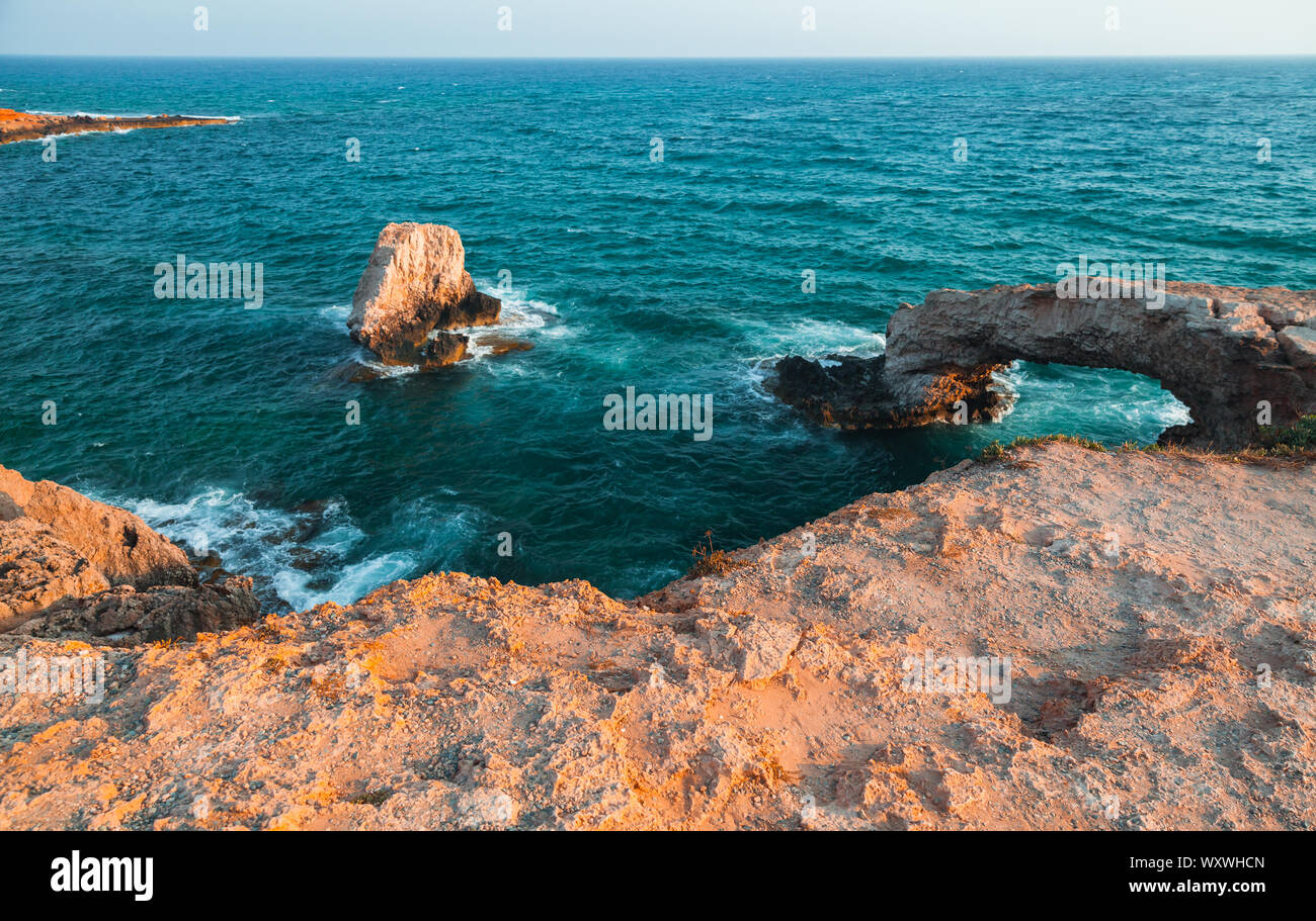 Natural stone arch known as the Love bridge. Mediterranean Sea coast ...