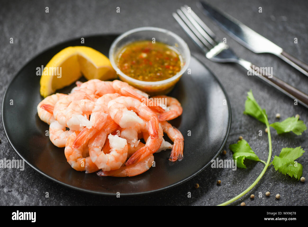 fresh shrimps served on plate with seafood sauce / boiled peeled shrimp ...