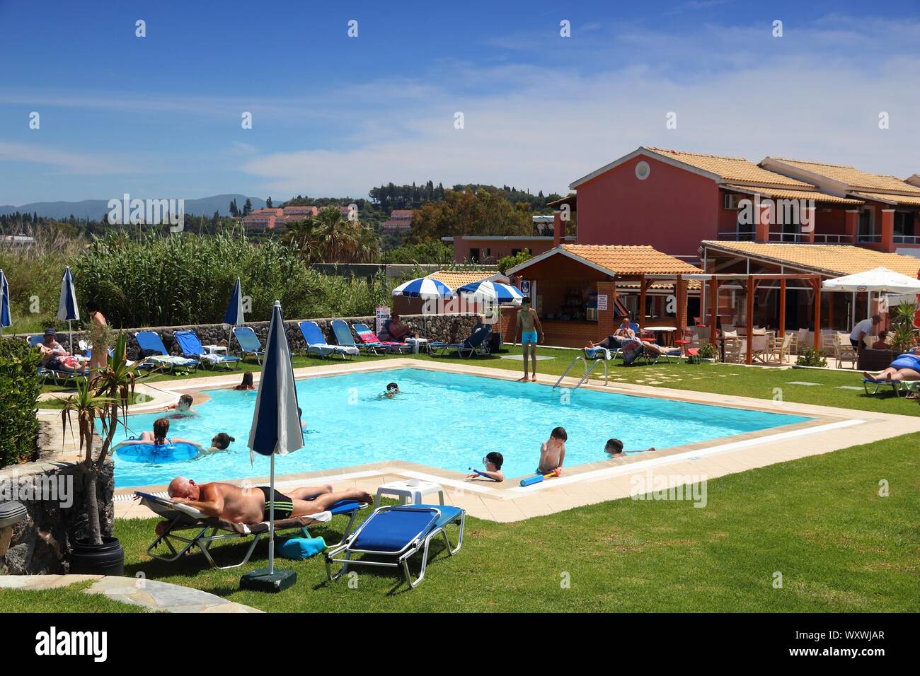 CORFU, GREECE - MAY 31, 2016: People visit generic vacation resort ...