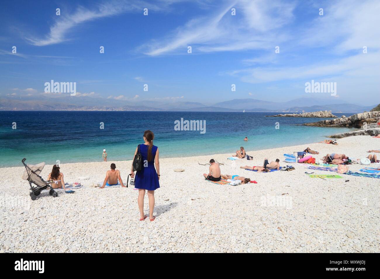 CORFU, GREECE - MAY 31, 2016: People enjoy the beach in Kassiopi, Corfu ...