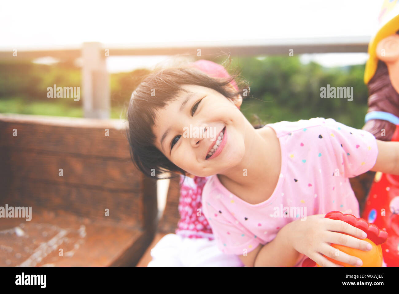 Children smile having fun little girl playing outside happy in the ...