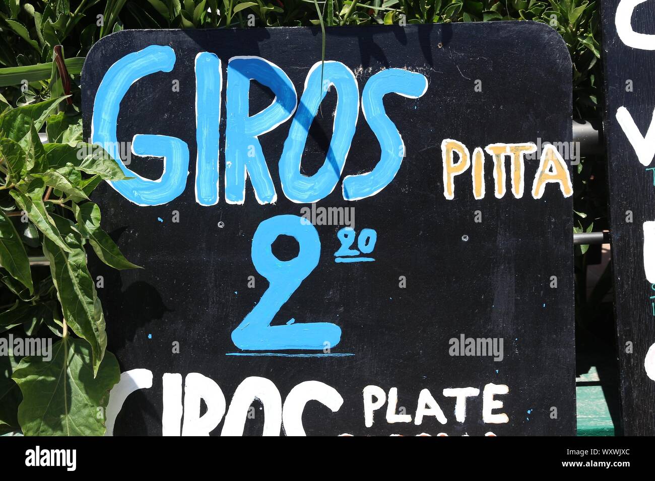 Restaurant menu in Corfu island - Greek cuisine blackboard. Pita gyros ...