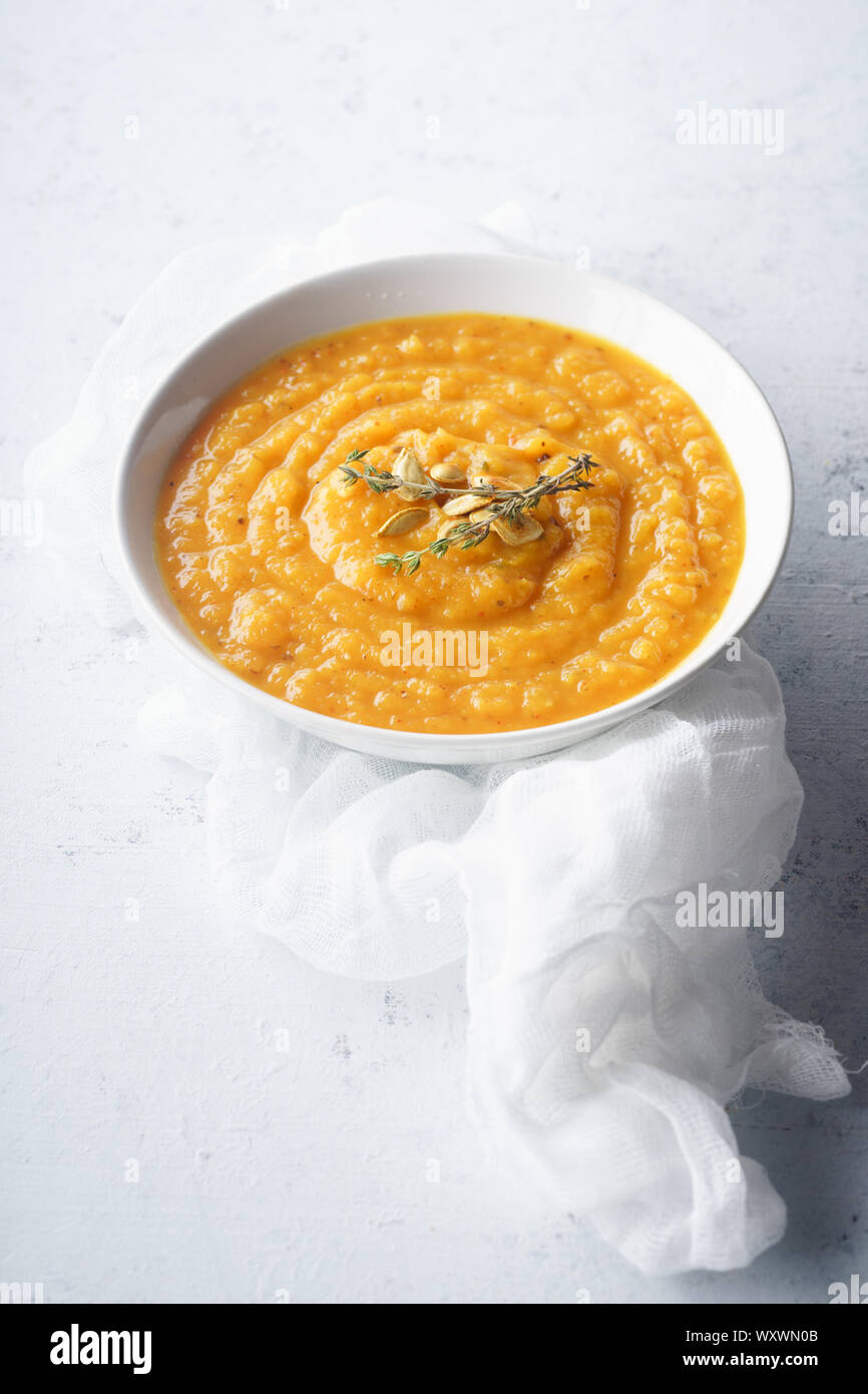 Pureed butternut squash soup with seeds and thyme. Warm food concept ...