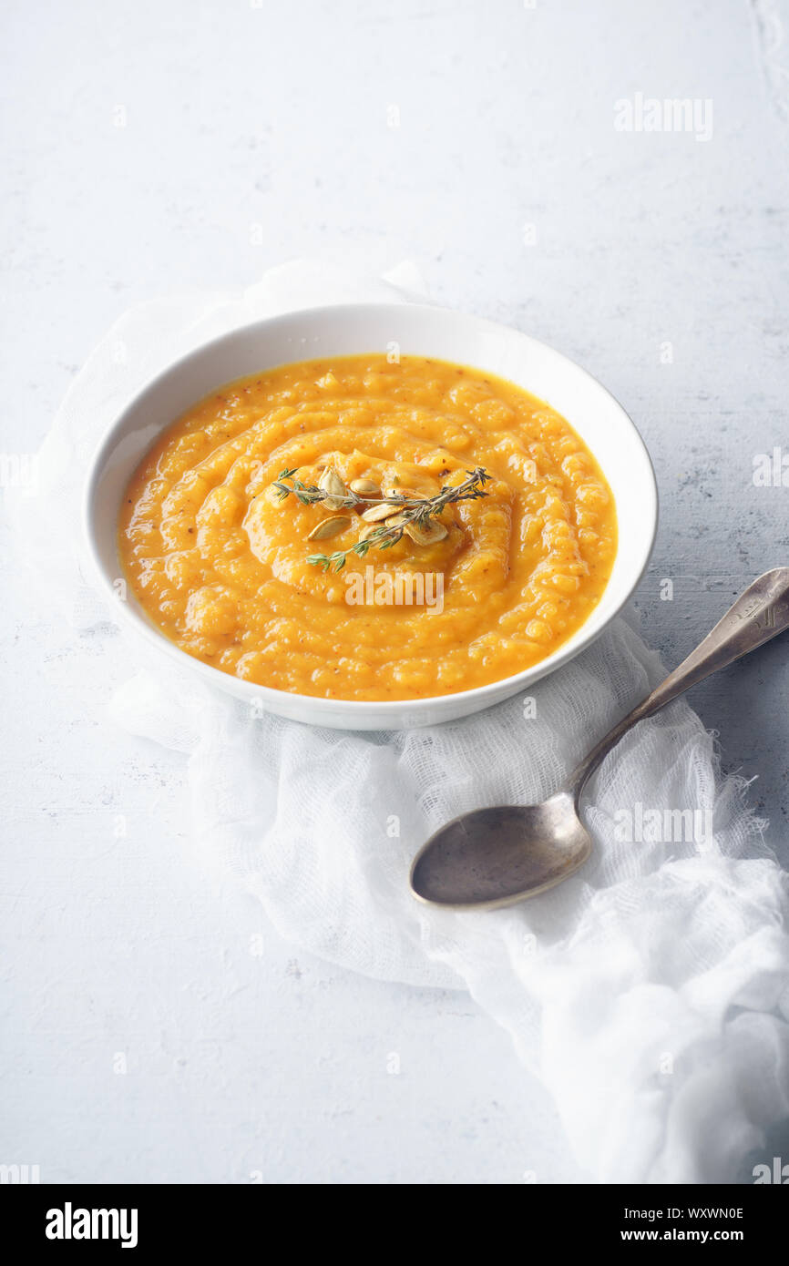 Pureed butternut squash soup with seeds and thyme. Warm food concept ...