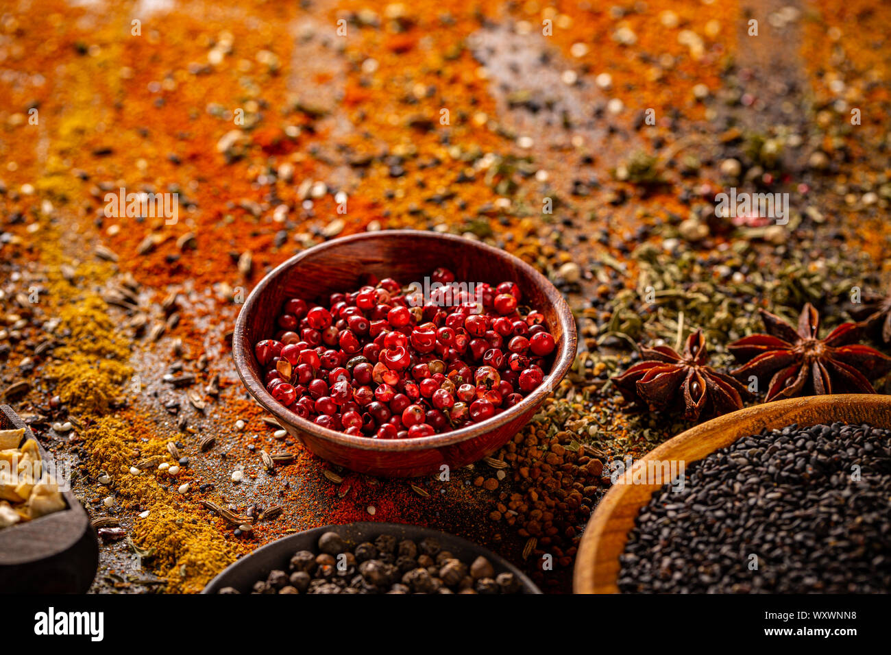 Red peppercorn in wooden bowl, spice concept Stock Photo - Alamy