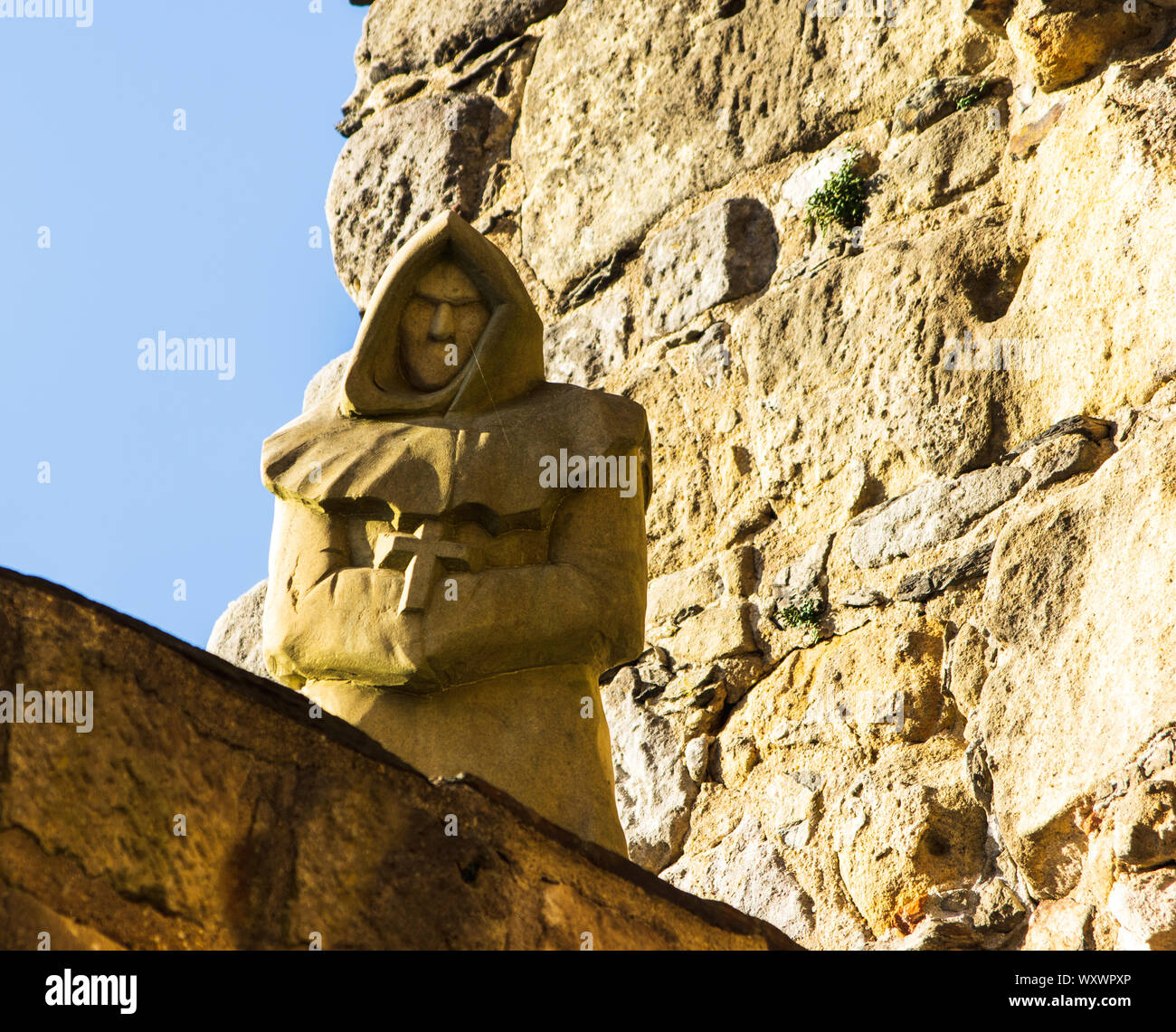 sandstone statue of a monk looking down Stock Photo - Alamy