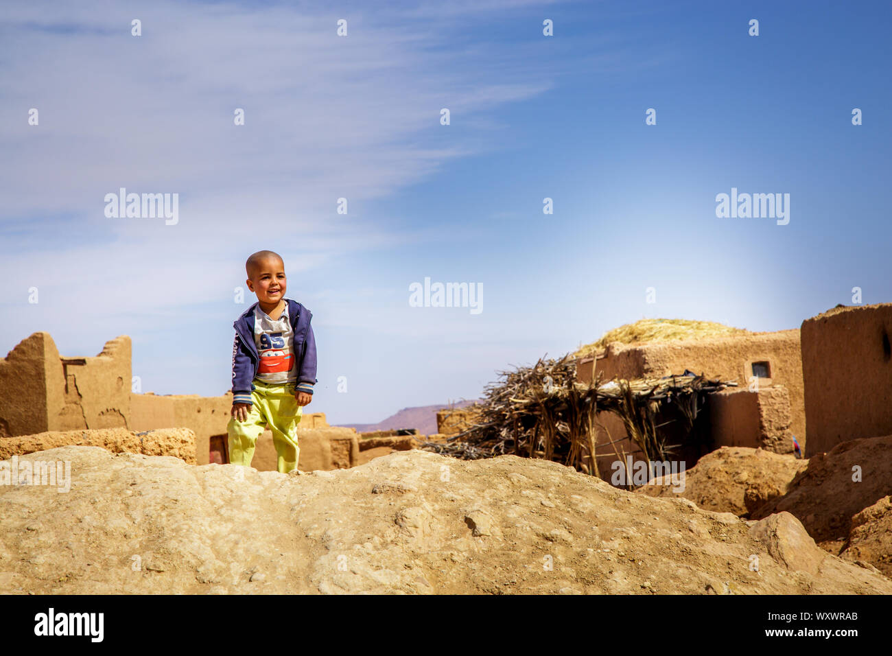 Small child playing alone outside home Stock Photo - Alamy