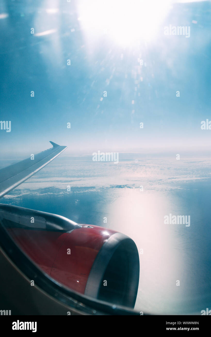 view of the cloudy sky, engine and wing of an airplane during the ...