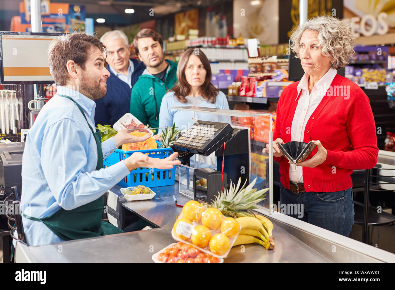 Customer at the checkout in the supermarket has too little money in the ...