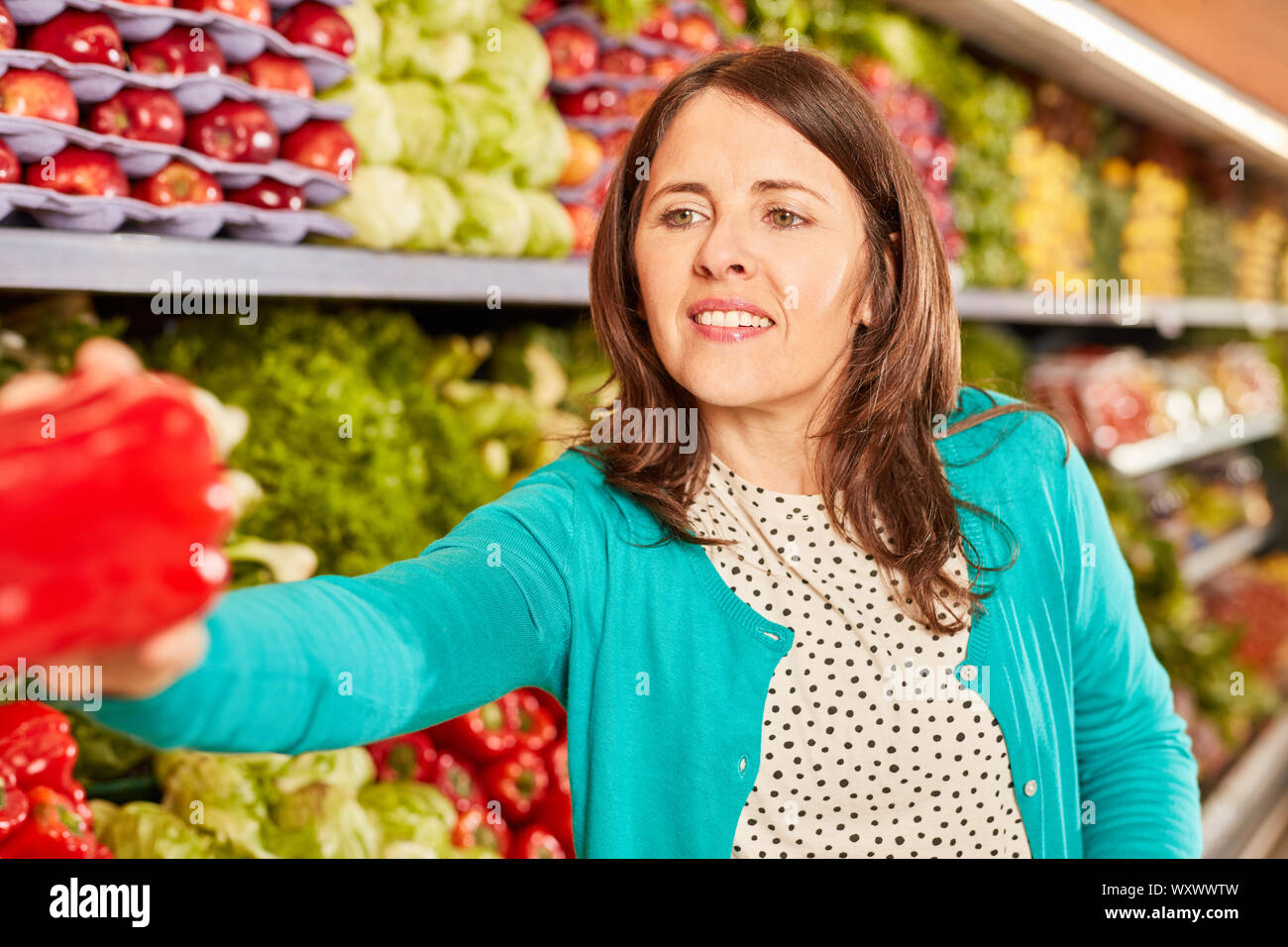 Young woman as customer and consumer while shopping vegetables in ...