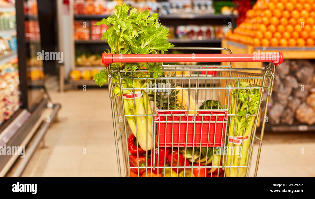Shopping cart full of healthy food in the supermarket Stock Photo - Alamy
