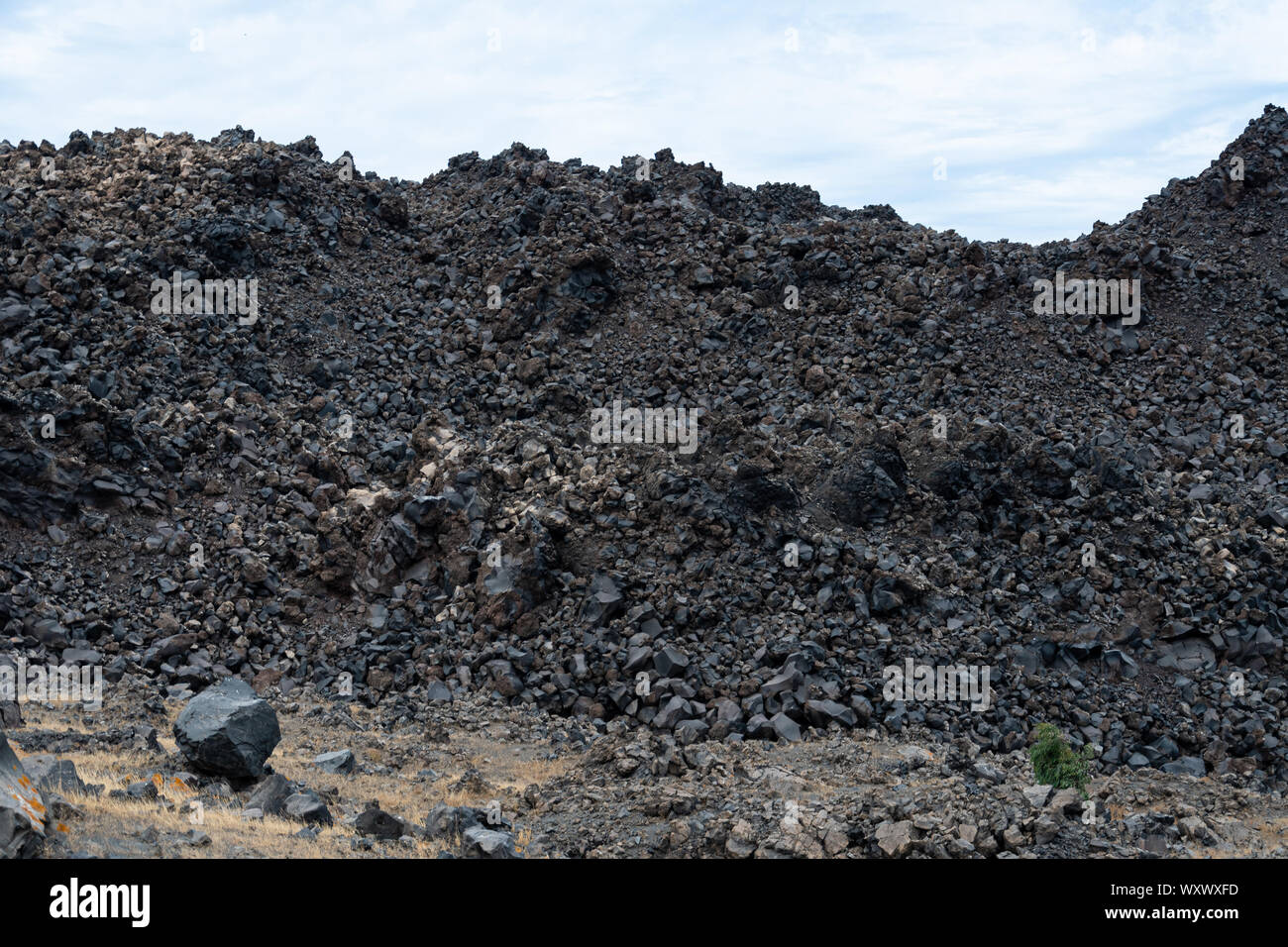 The black basalt rocks of Nea Kameni Island, the dome of the Santorini ...