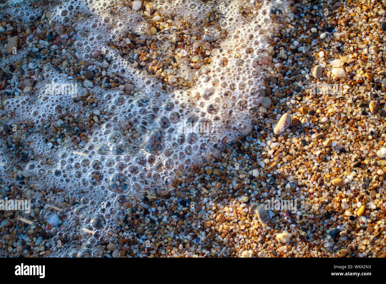 sea pebbles colored granite on the beach background stones. The shore ...