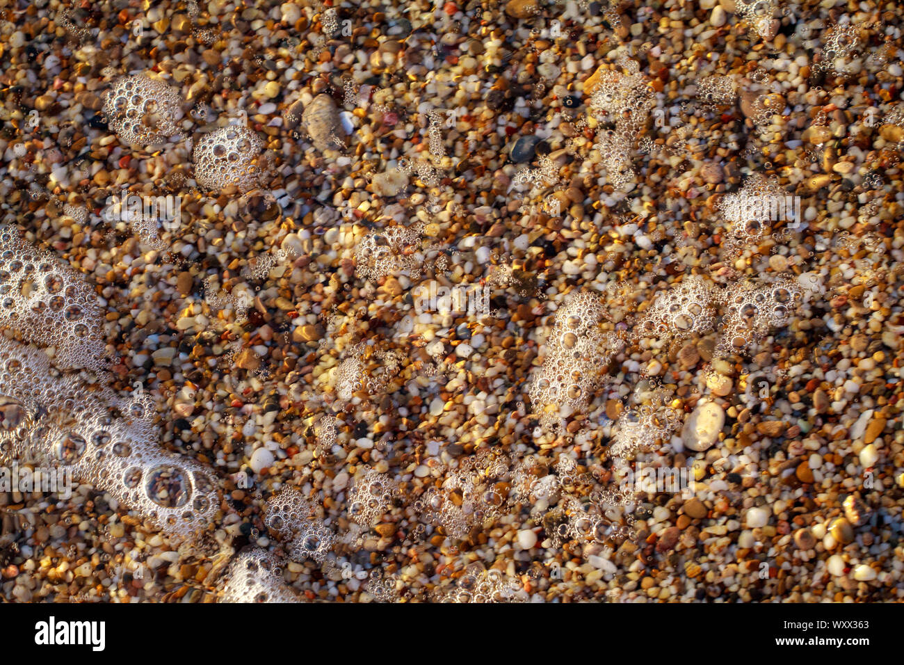 sea pebbles colored granite on the beach background stones. The shore ...