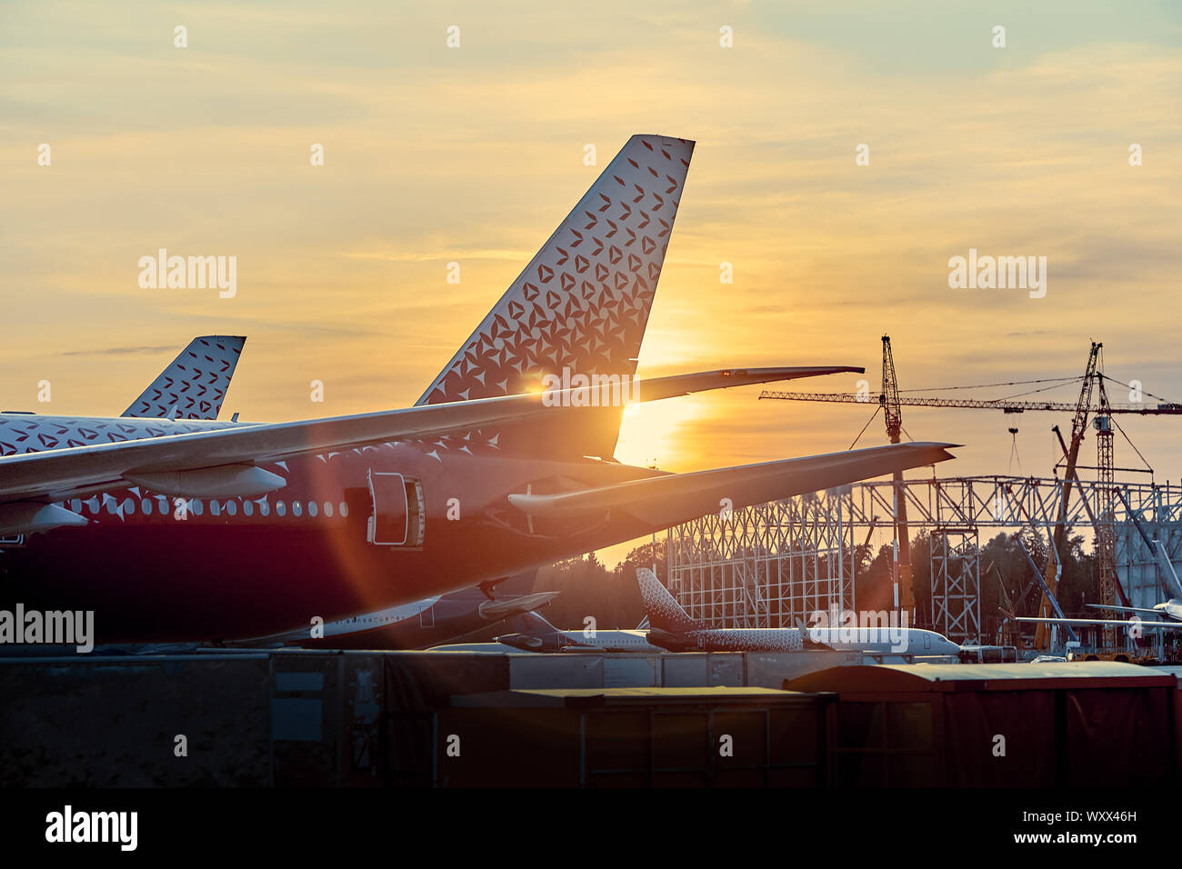 Modern passenger airplane parked to terminal building gate at airside ...