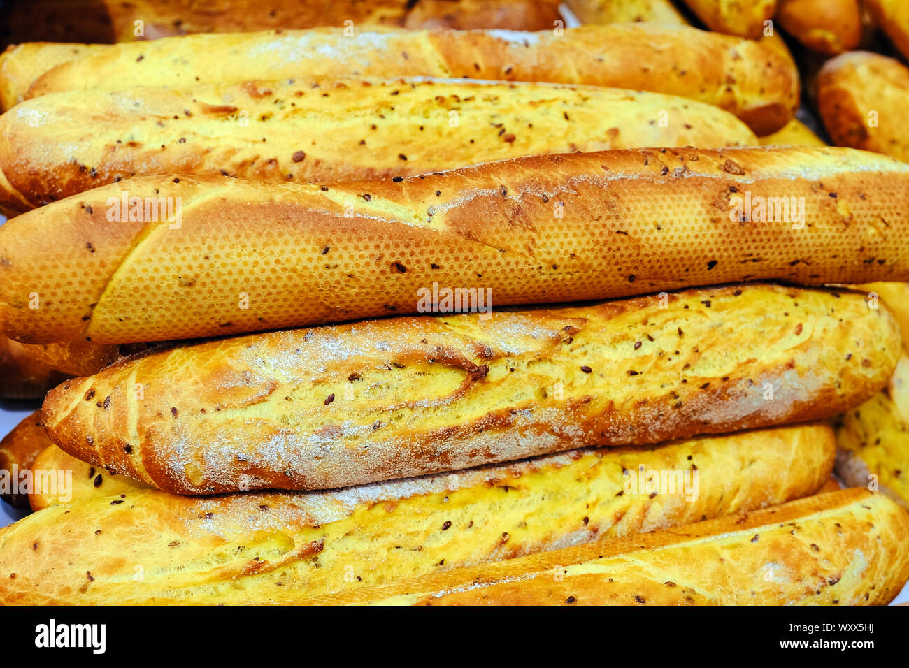 Different bread on the shelves in the bakery. Fresh baguette with corn ...
