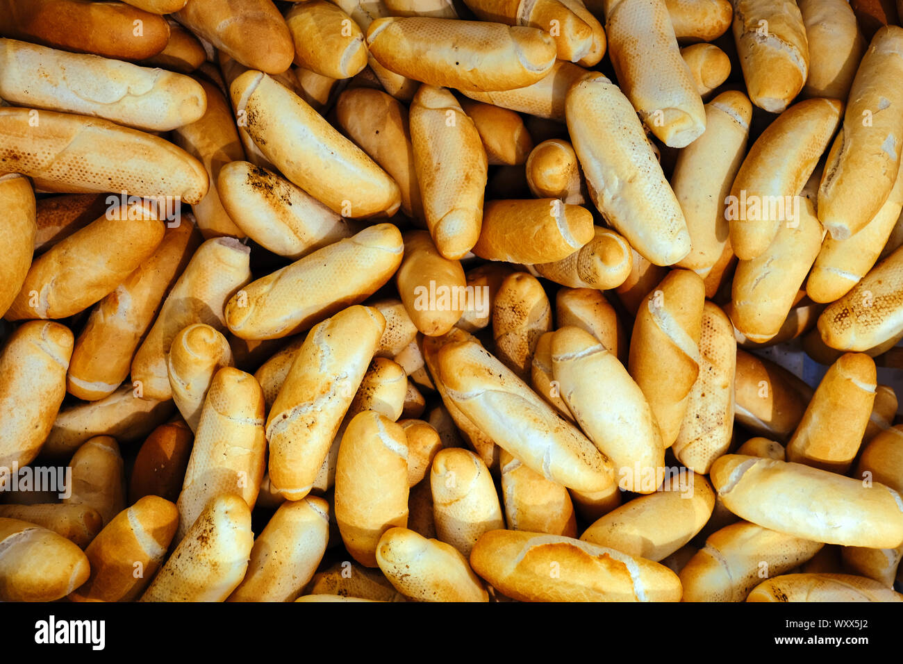 Different bread on the shelves in the bakery. Fresh rolls in ...