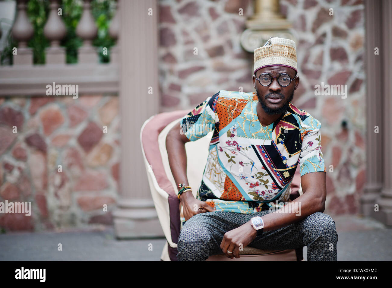 Handsome afro american man wearing traditional clothes, cap and ...