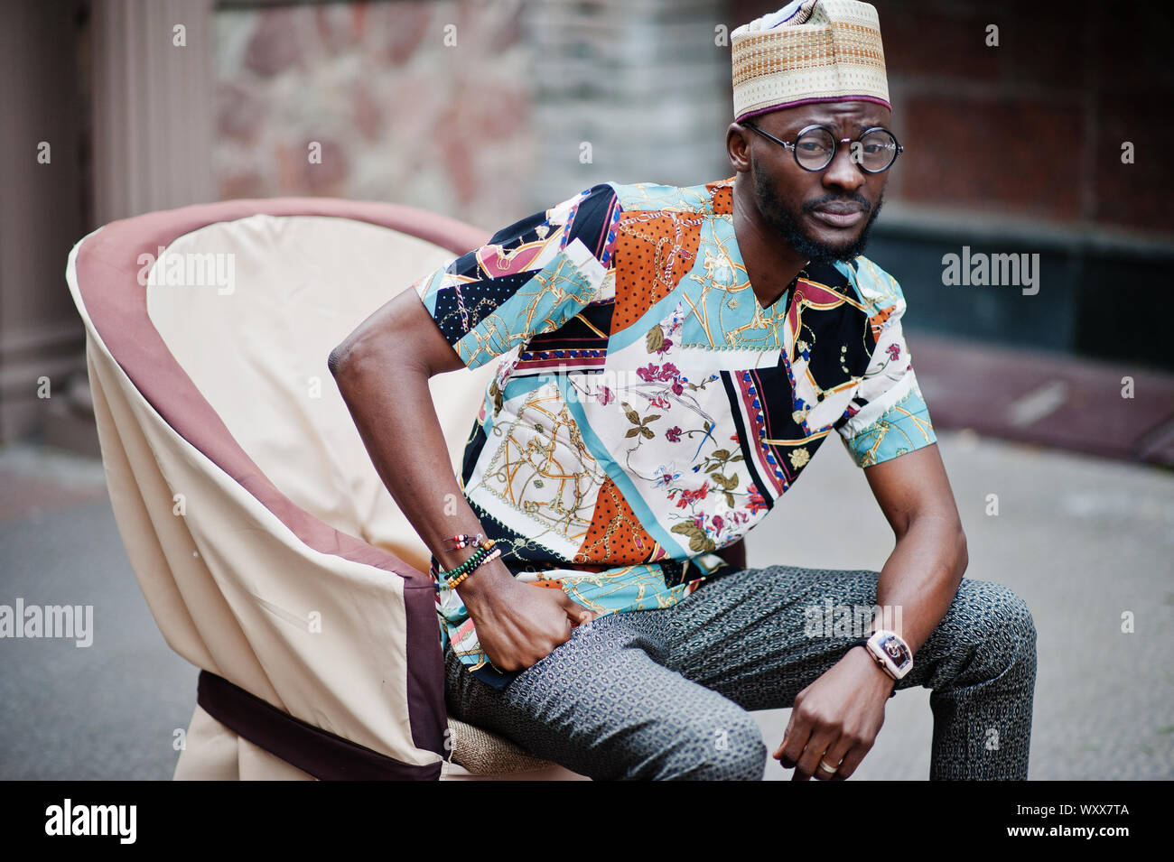 Handsome afro american man wearing traditional clothes, cap and ...