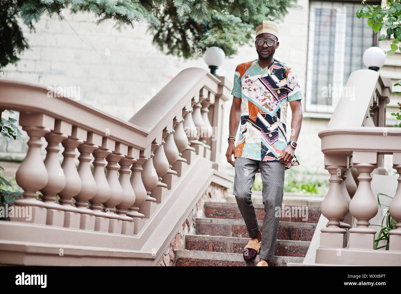 Handsome afro american man wearing traditional clothes, cap and ...