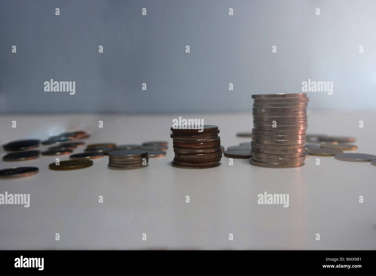 Growing coins The concept of inflation Stock Photo - Alamy