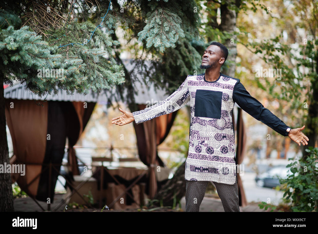 Handsome afro american man wearing traditional clothes in modern city ...