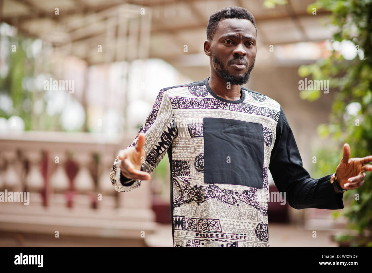 Handsome afro american man wearing traditional clothes in modern city ...