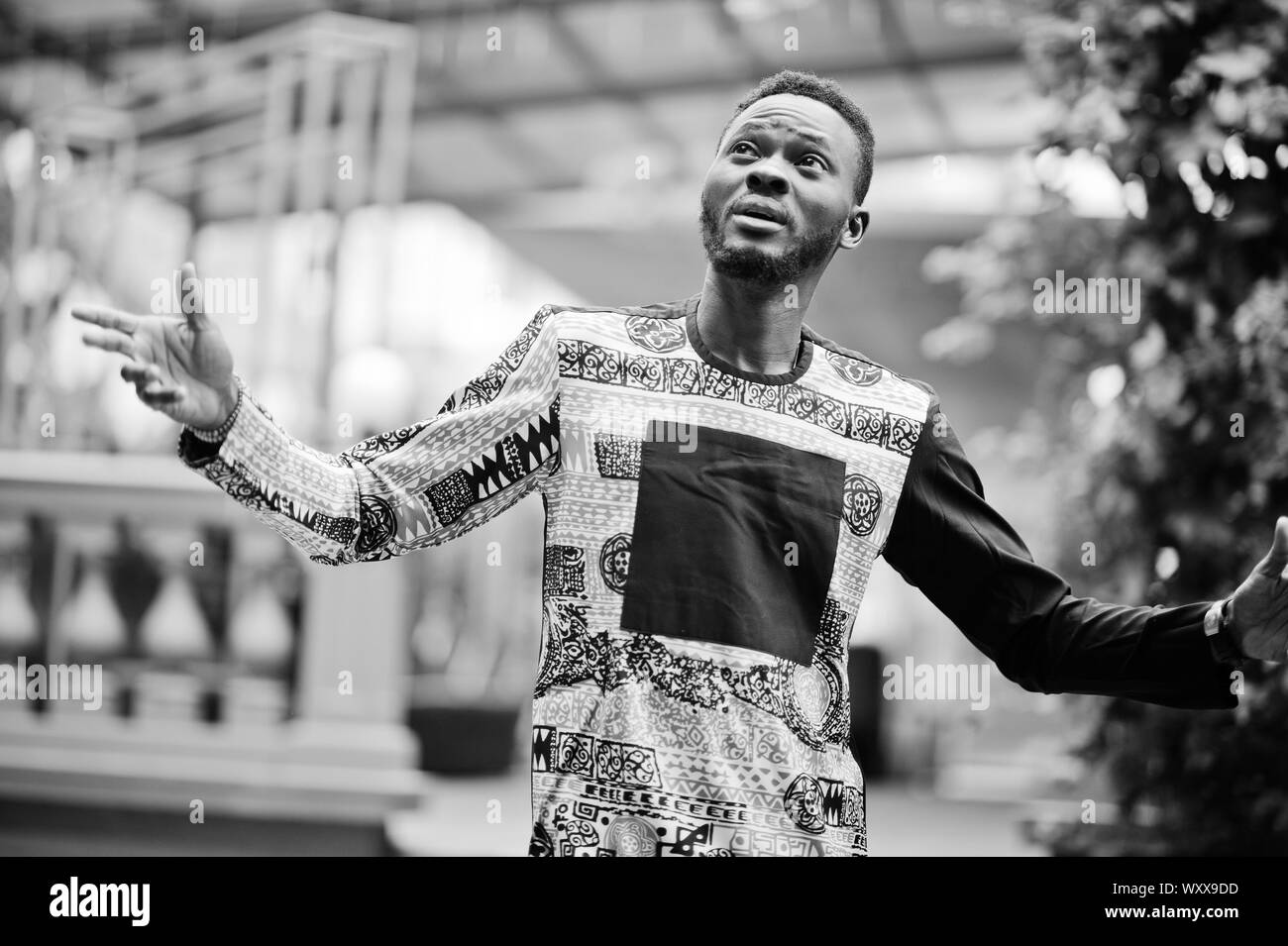 Handsome afro american man wearing traditional clothes in modern city ...