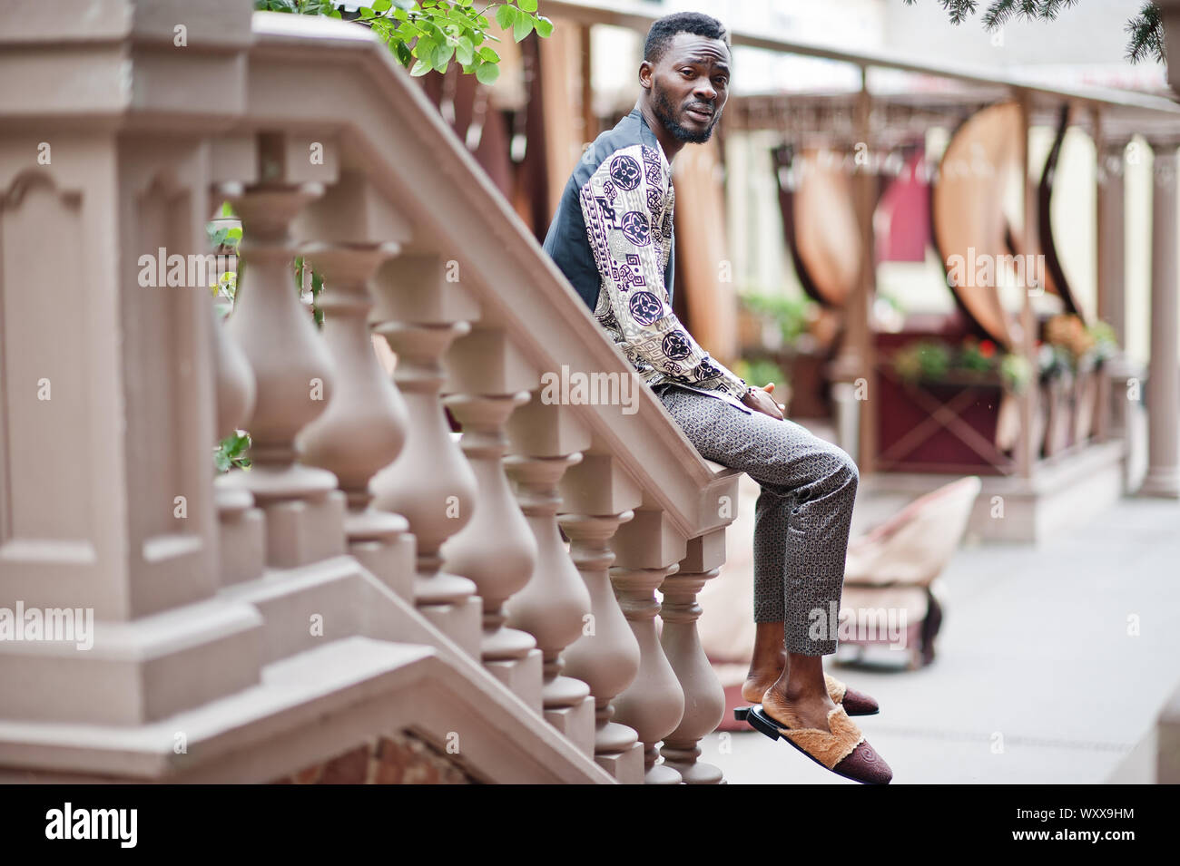 Handsome afro american man wearing traditional clothes in modern city ...