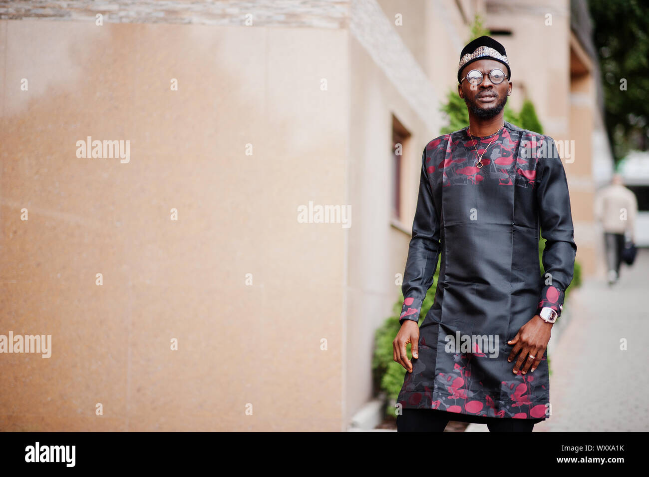 Handsome afro american man wearing traditional clothes, cap and ...