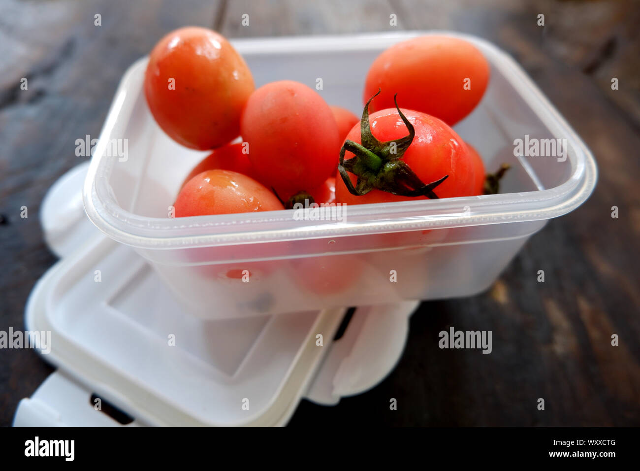Fresh tomatoes, plastic boxes, side view Stock Photo - Alamy