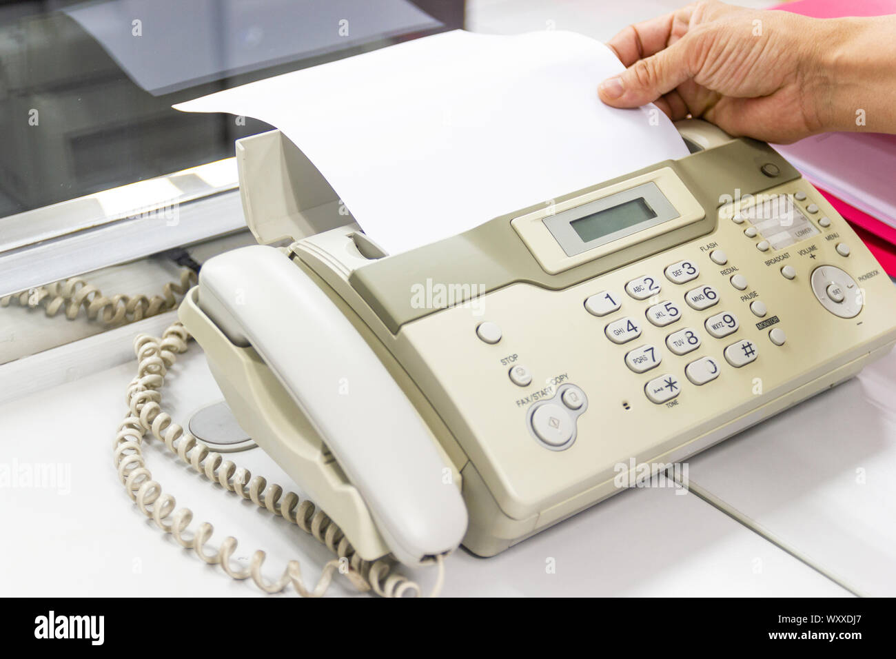 hand man are using a fax machine in the office, equipment for data ...