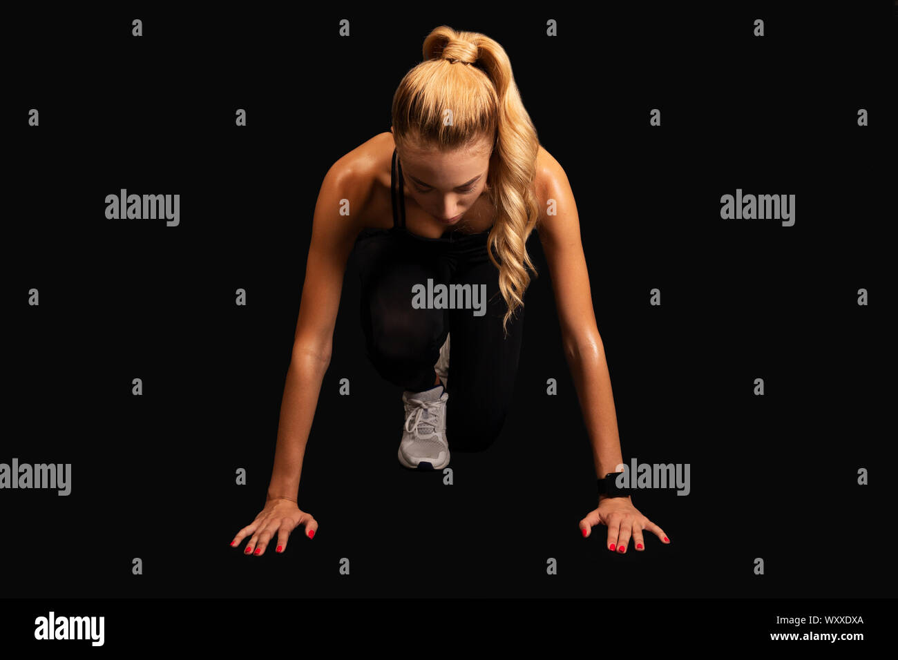 Determined Girl Standing In Ready To Run Position, Black Background ...
