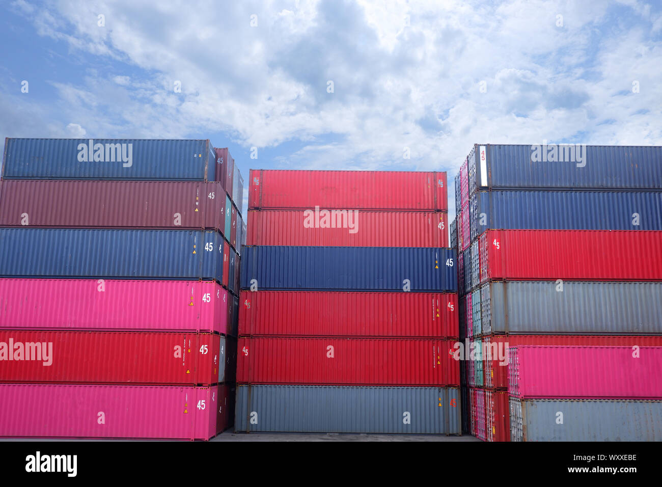Container stack Bright sky background Stock Photo - Alamy