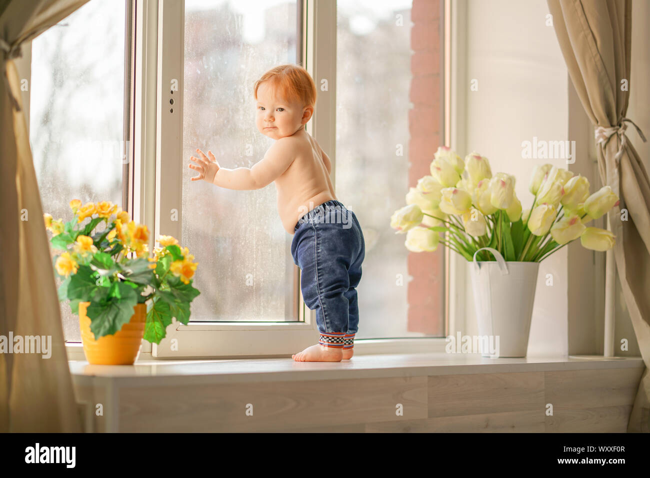 a little boy looks in the window. a dangerous situation when a small ...