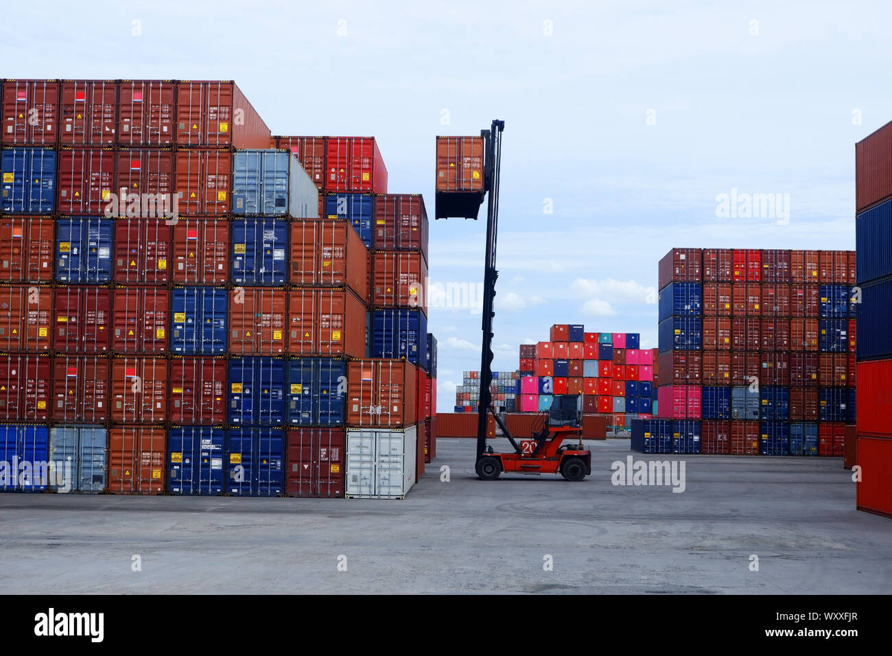 Cranes lifting containers in the port warehouses Stock Photo - Alamy