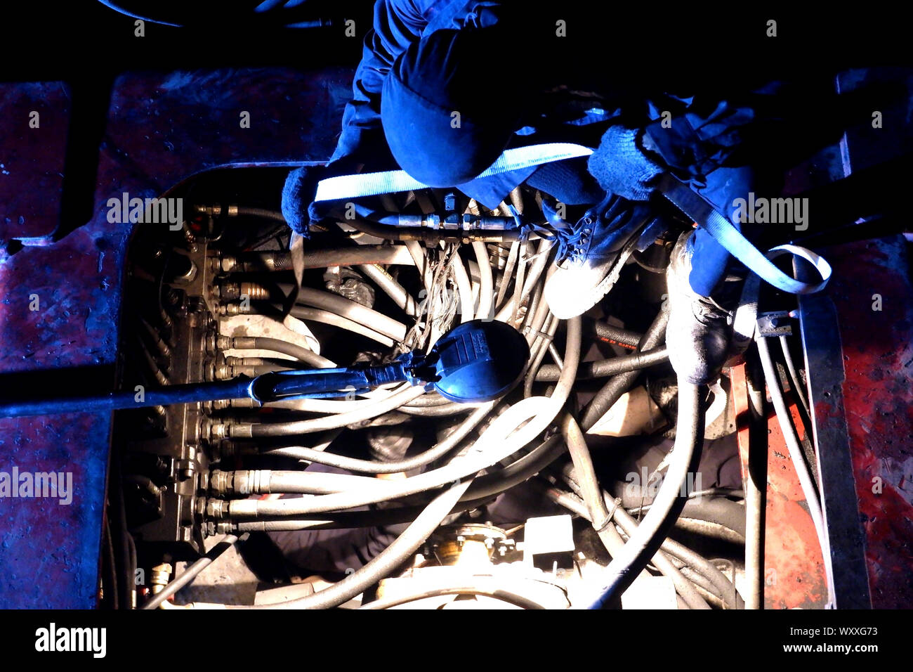 The mechanic is repairing the engine. at night Stock Photo - Alamy