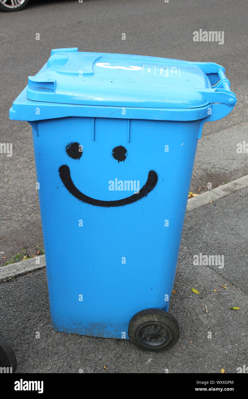 Blue recycling wheelie bin with smiley face Stock Photo - Alamy