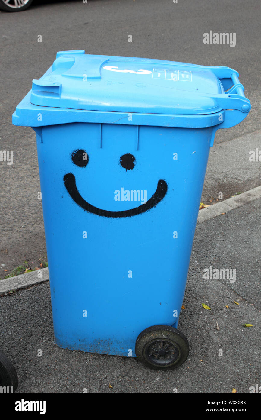 Blue recycling wheelie bin with smiley face Stock Photo - Alamy
