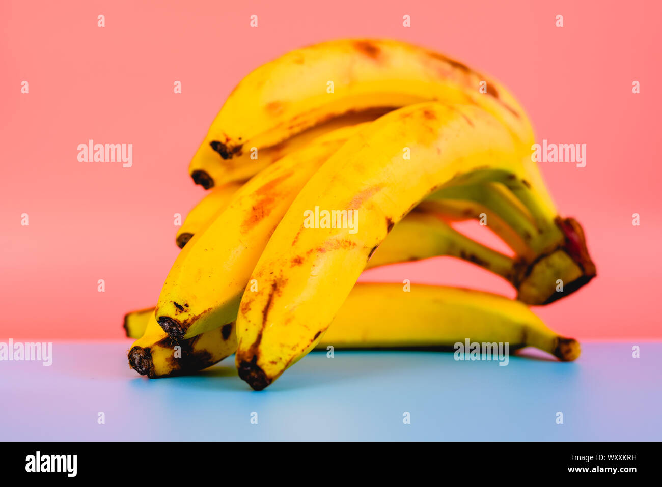 Ripe bananas of intense yellow color with black specks, isolated on a ...