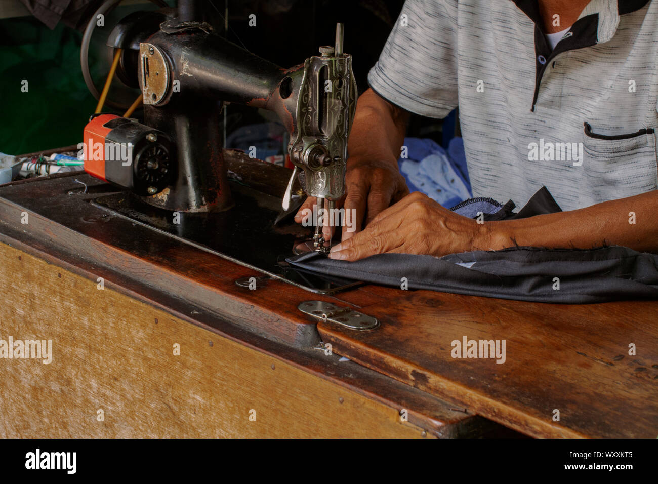 A traditional tailor in action at work Stock Photo - Alamy