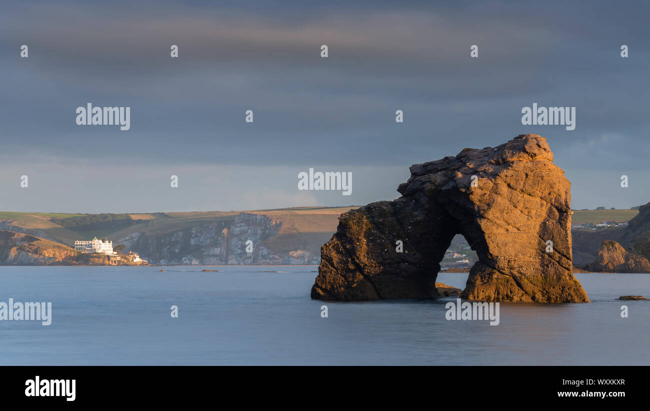 Thurlestone Rock Devon England at sunset with a calm smooth sea and ...