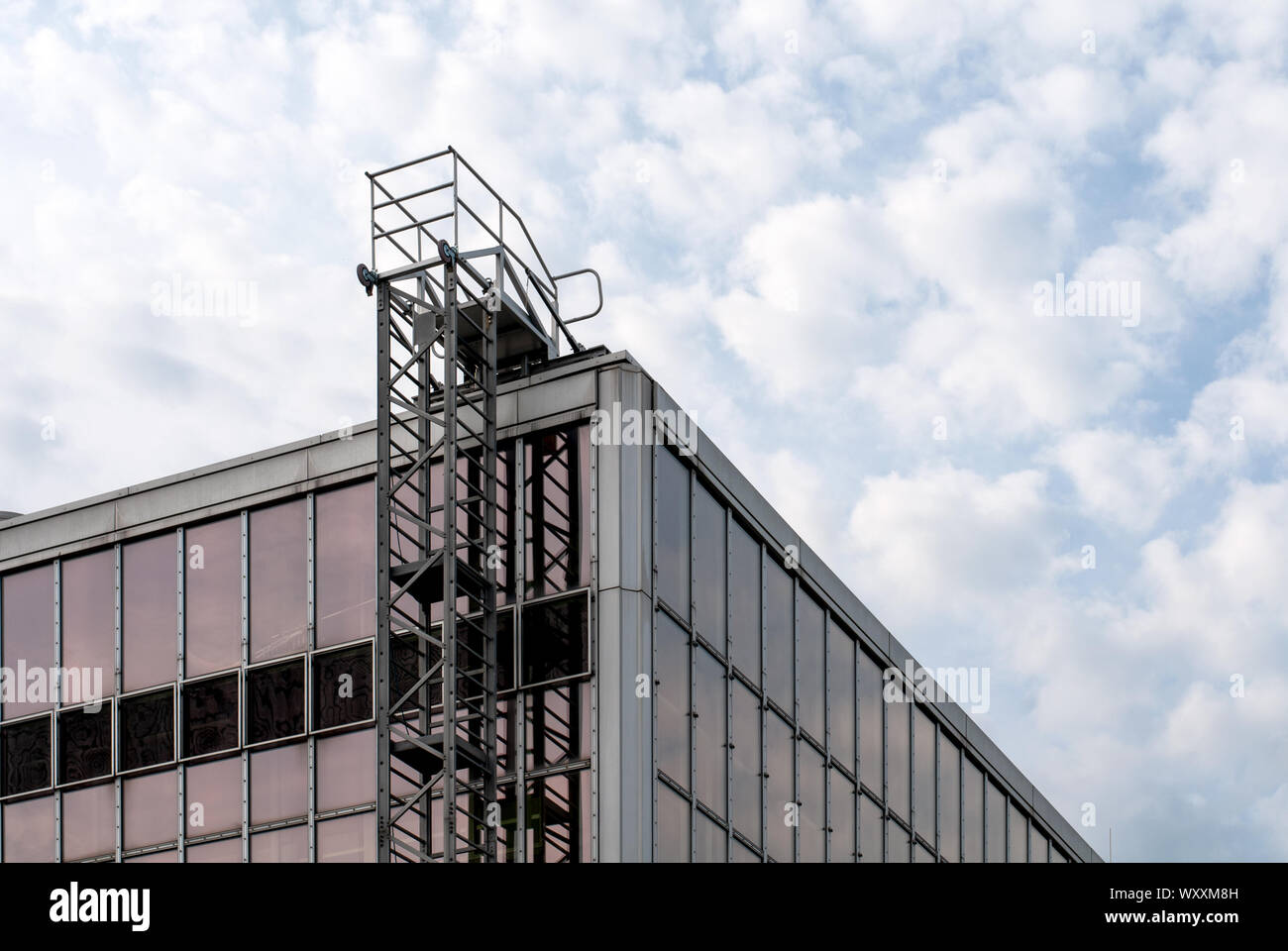 metal ladder at glass facade of an office building to be used for ...