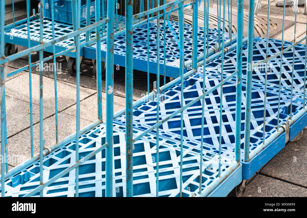 roll containers behind market stall, transport equipment for vegetable ...