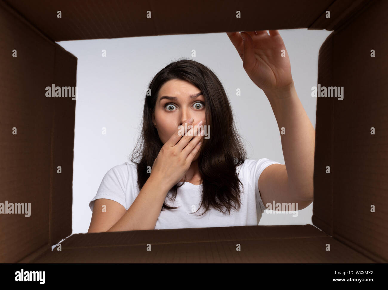Shocked Lady Looking Inside Cardboard Moving Box Stock Photo - Alamy