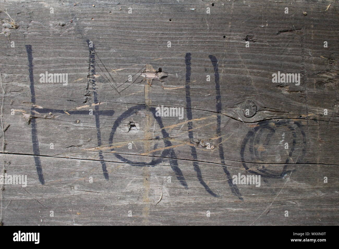 Old weathered wooden tile with hallo written in black on it Stock Photo ...