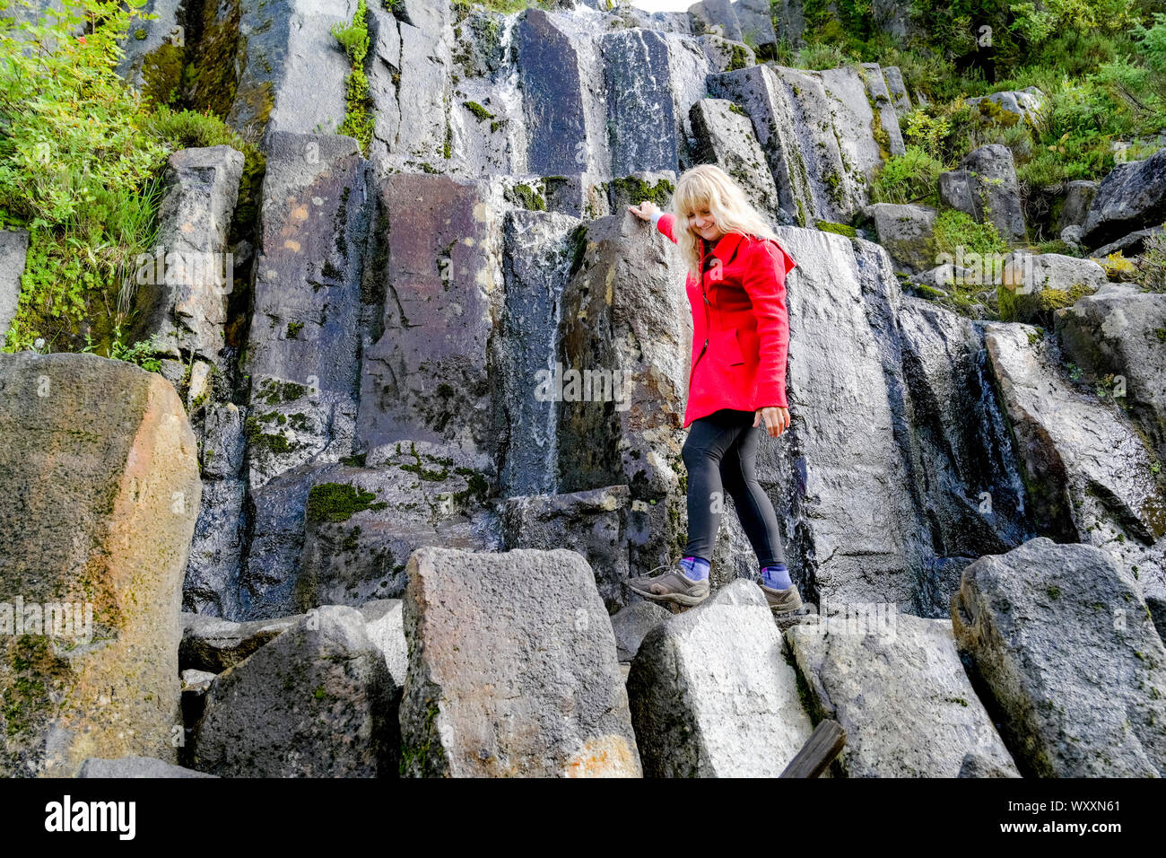 Woman on trail with columnar basalt rocks, Bagley Lakes trail, , Mount ...