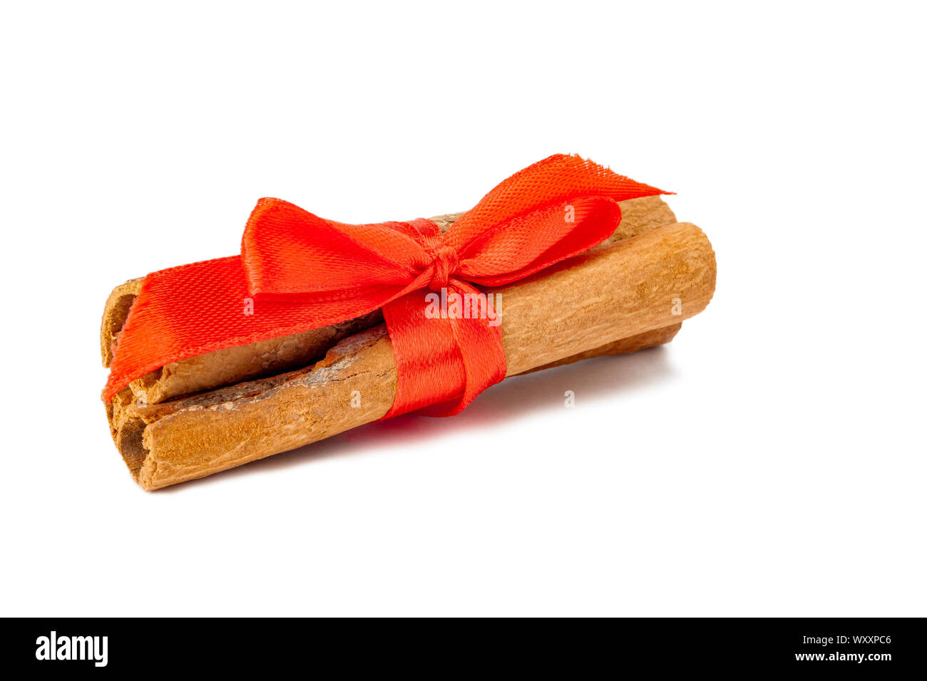 Cinnamon tied with a red ribbon, closeup on a white background Stock ...