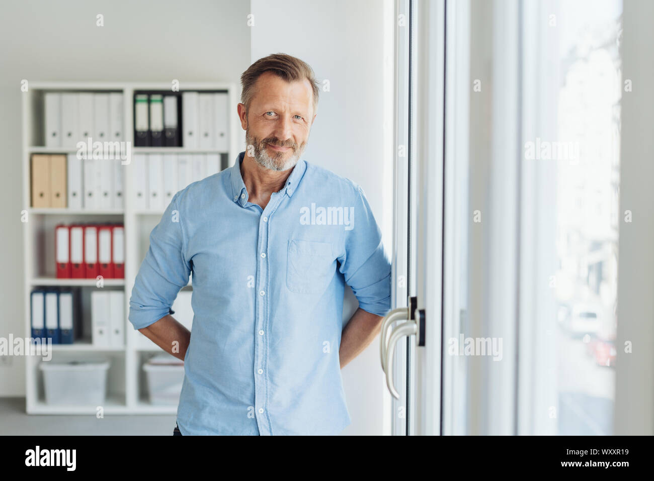 Businessman standing behind glass hi-res stock photography and images ...