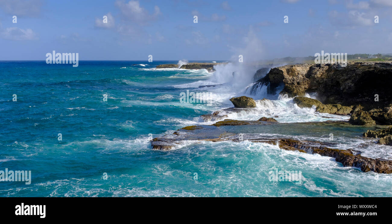 Ocean waves crash against the rocky cliffs of North Point, Barbados ...